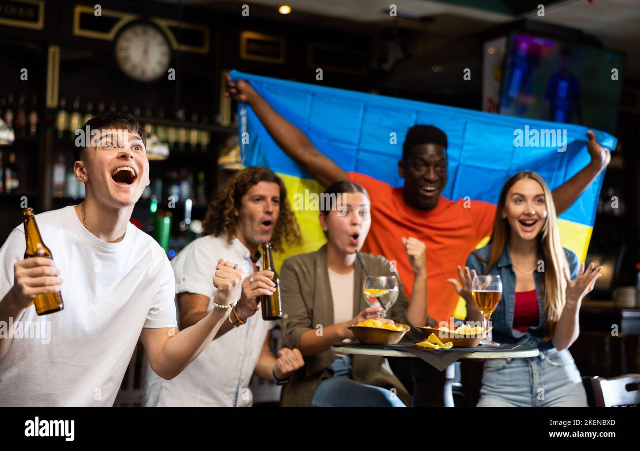 Happy friends of different ages drinking beer and celebrating the ...