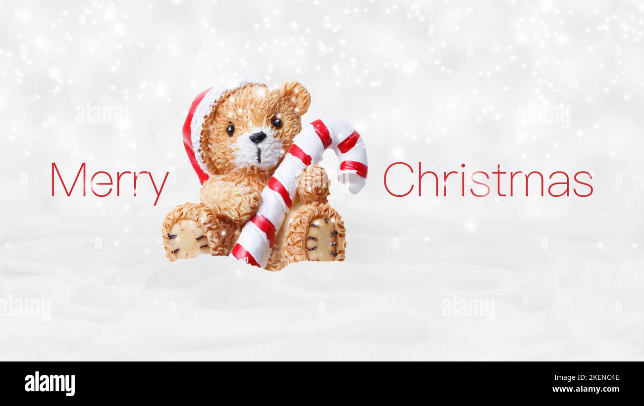 Merry Christmas text and teddy bear with red hat and candy striped cane ...