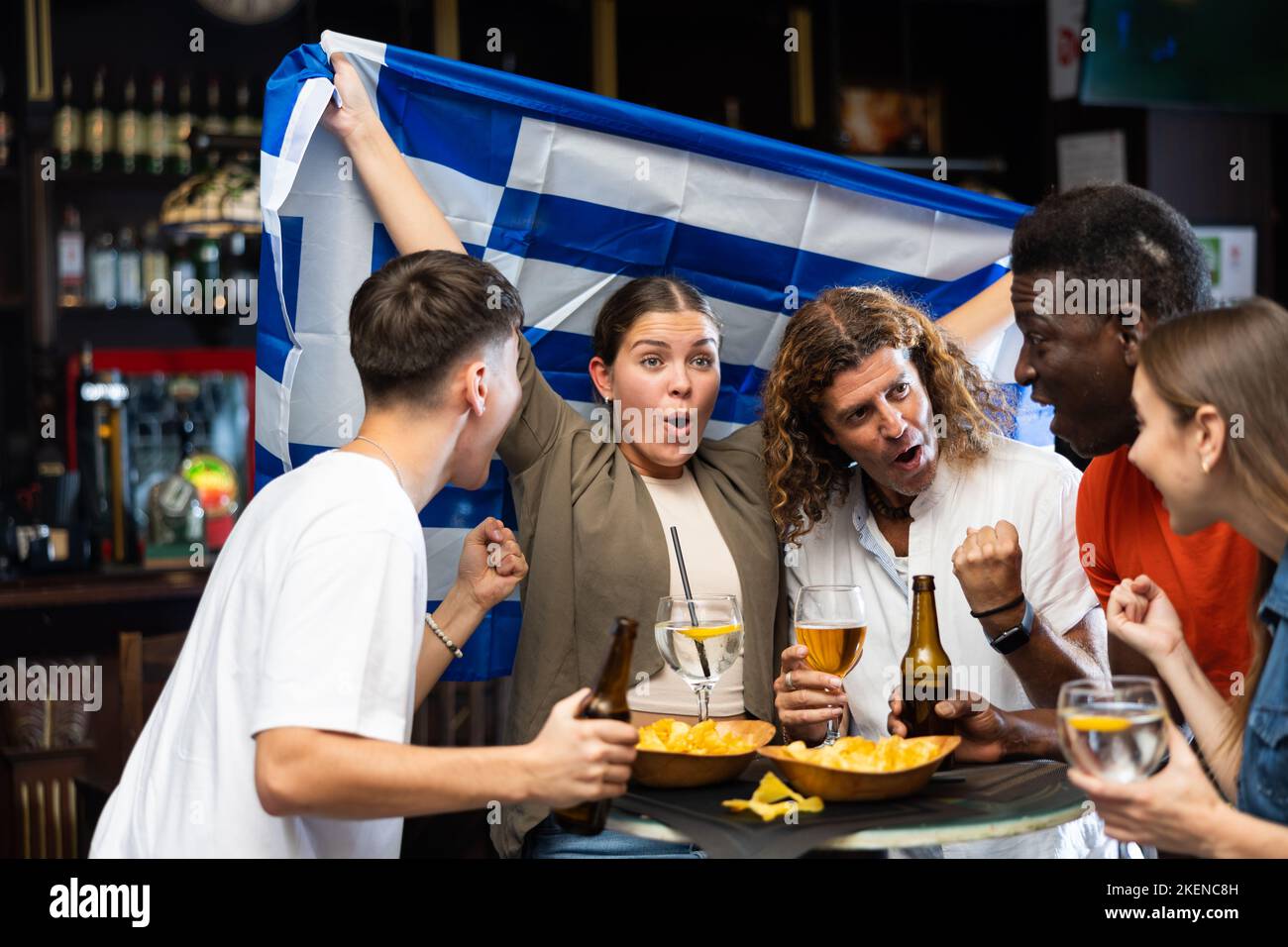 Group of Greece football team fans spending time in bar Stock Photo - Alamy