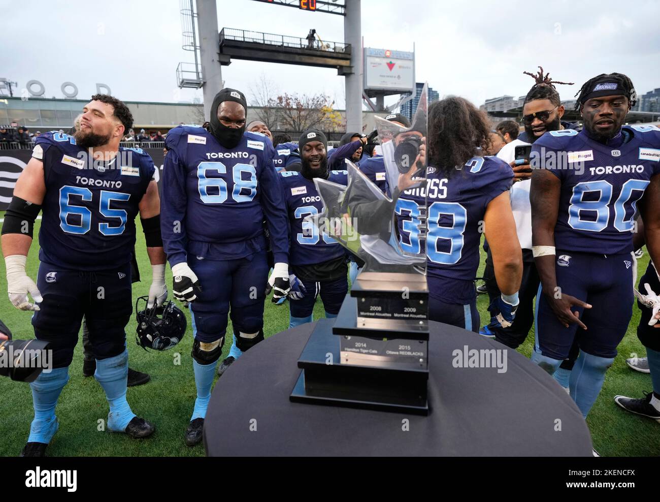 Toronto Argonauts players look at the CFL East division trophy after ...
