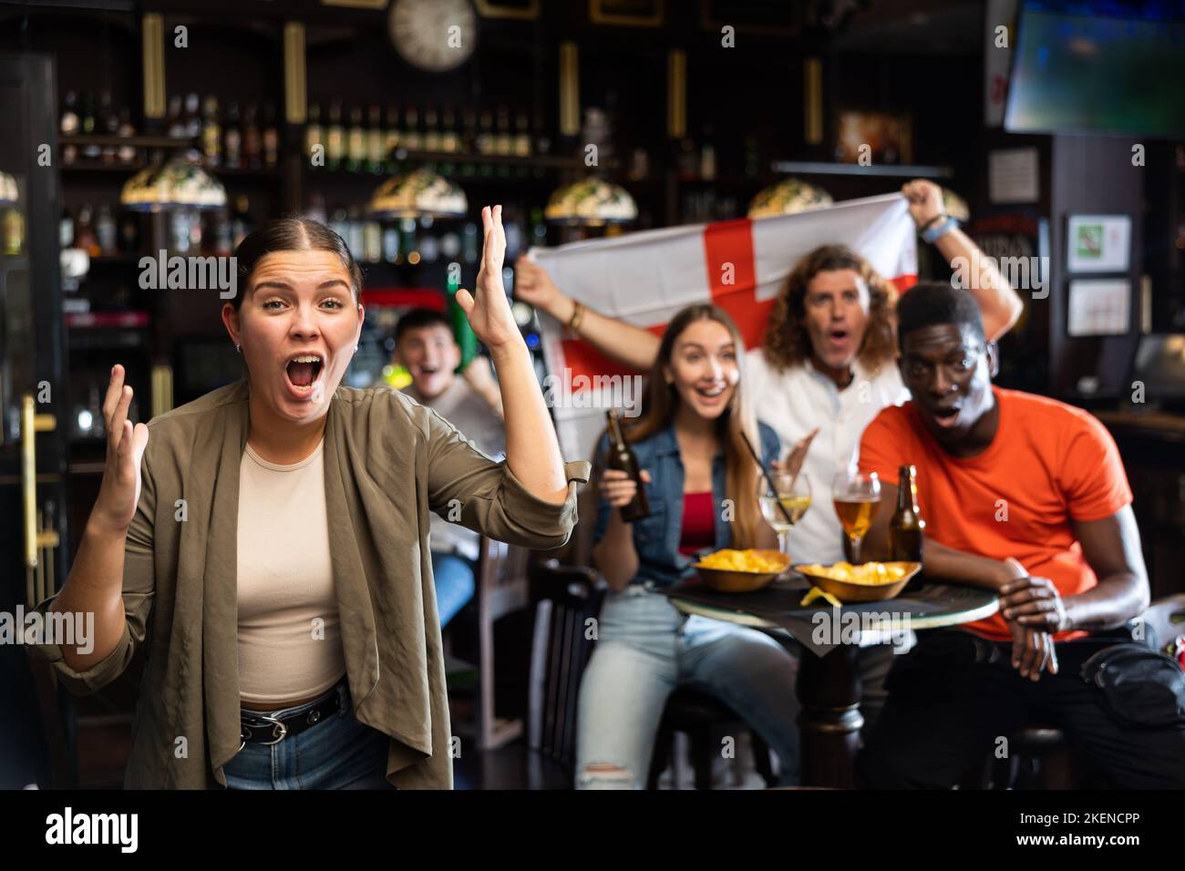 Cheerful multiracial soccer fans waving the flag of England and ...