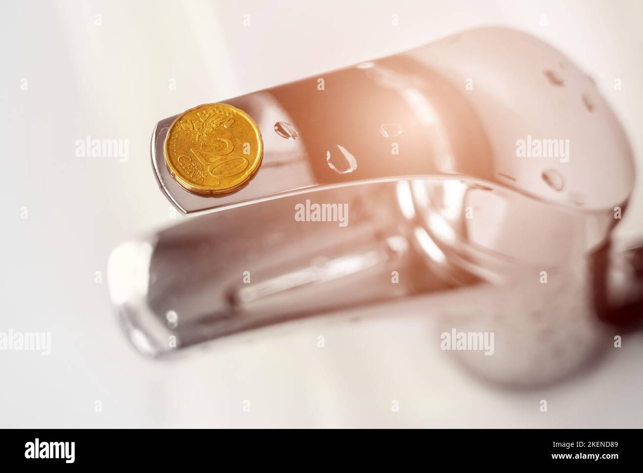 Coin on a bathroom water faucet. Concept of economic crisis and ...
