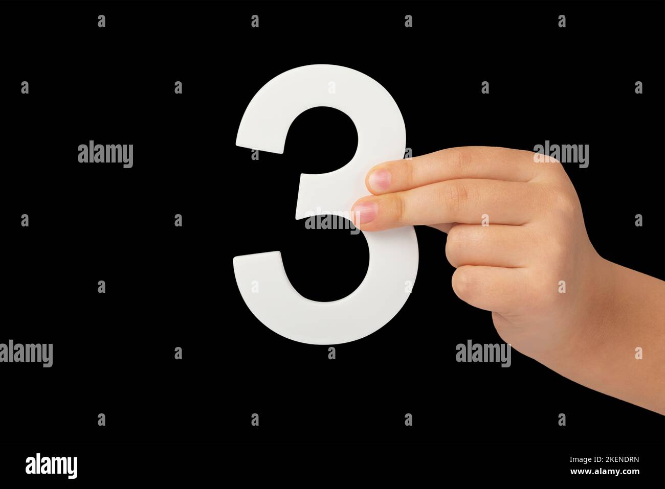 number three in hand isolated on black background. Number three in a ...