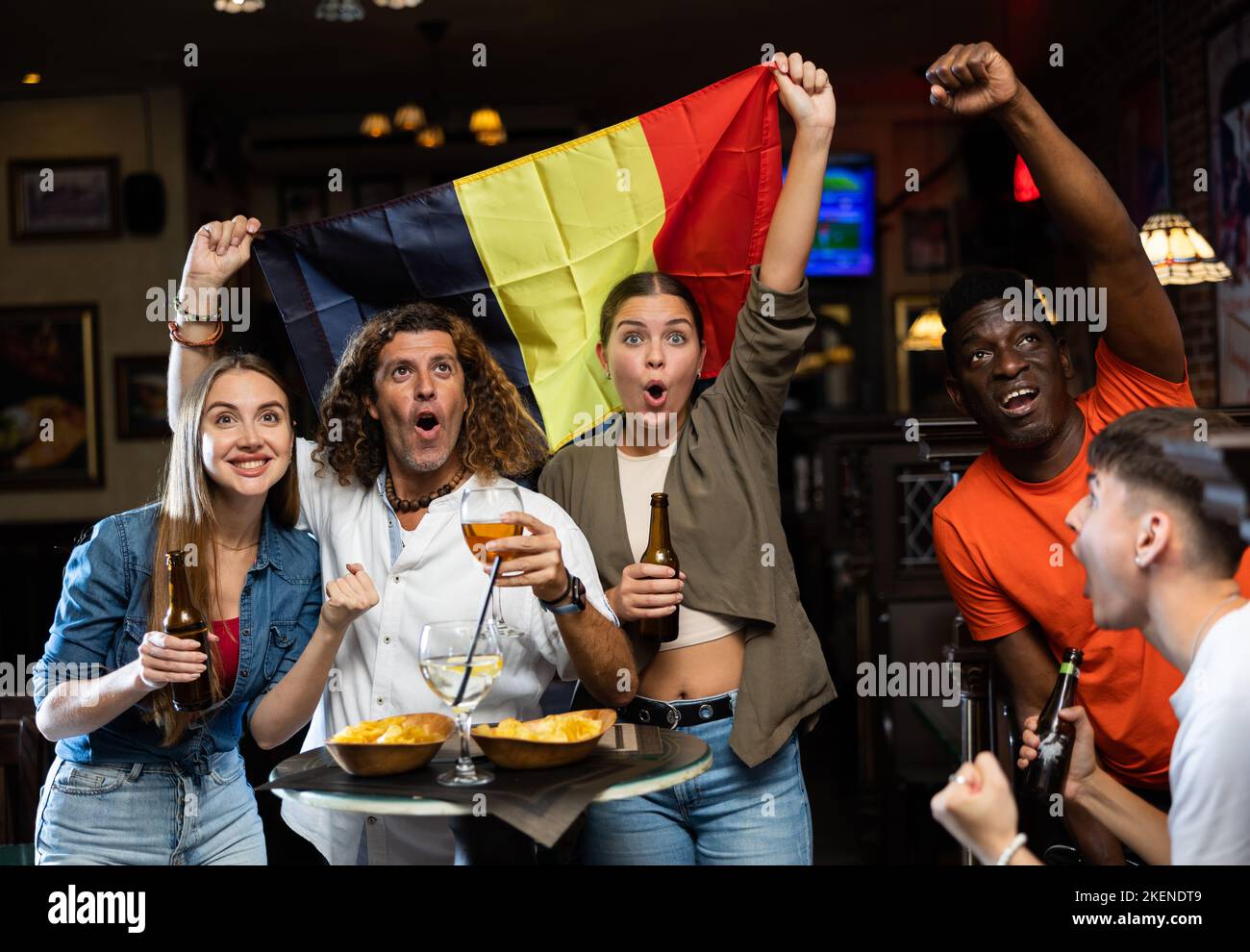 Happy fans celebrating the victory of Belgian team in bar Stock Photo ...