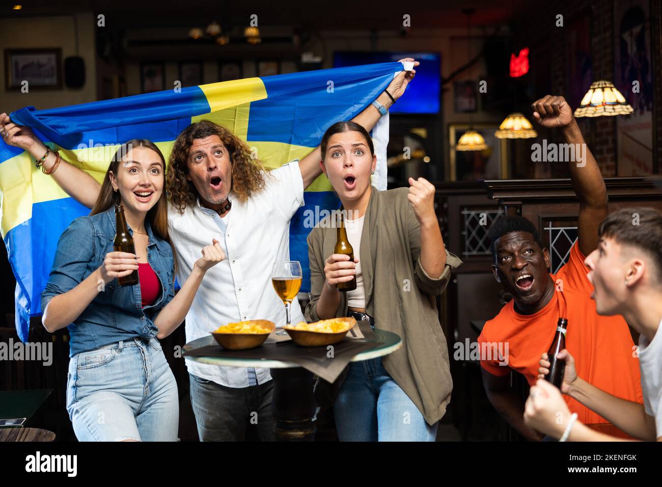 Happy football fans celebrating victory of favorite Swedish team in ...