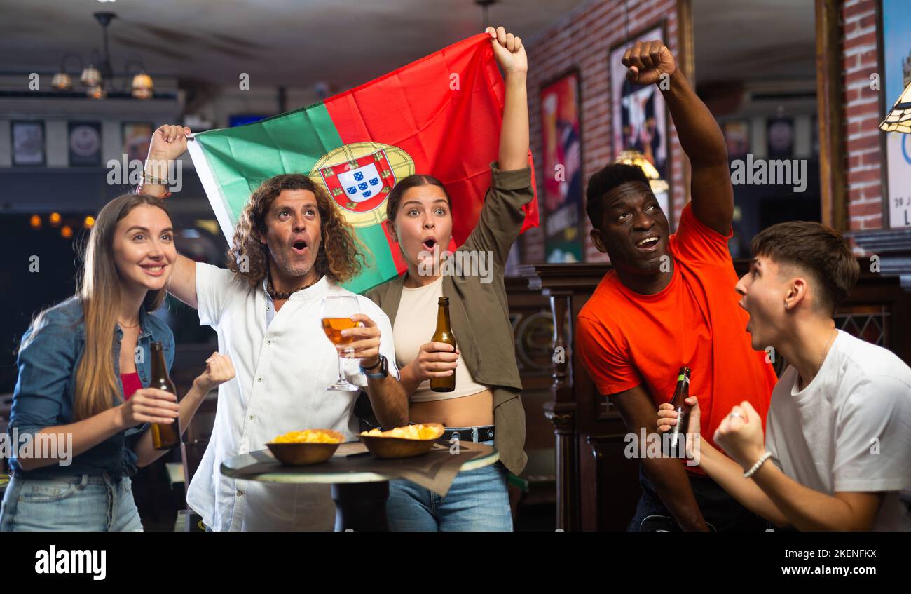 Excited football fans celebrating victory of favorite Portuguese team ...