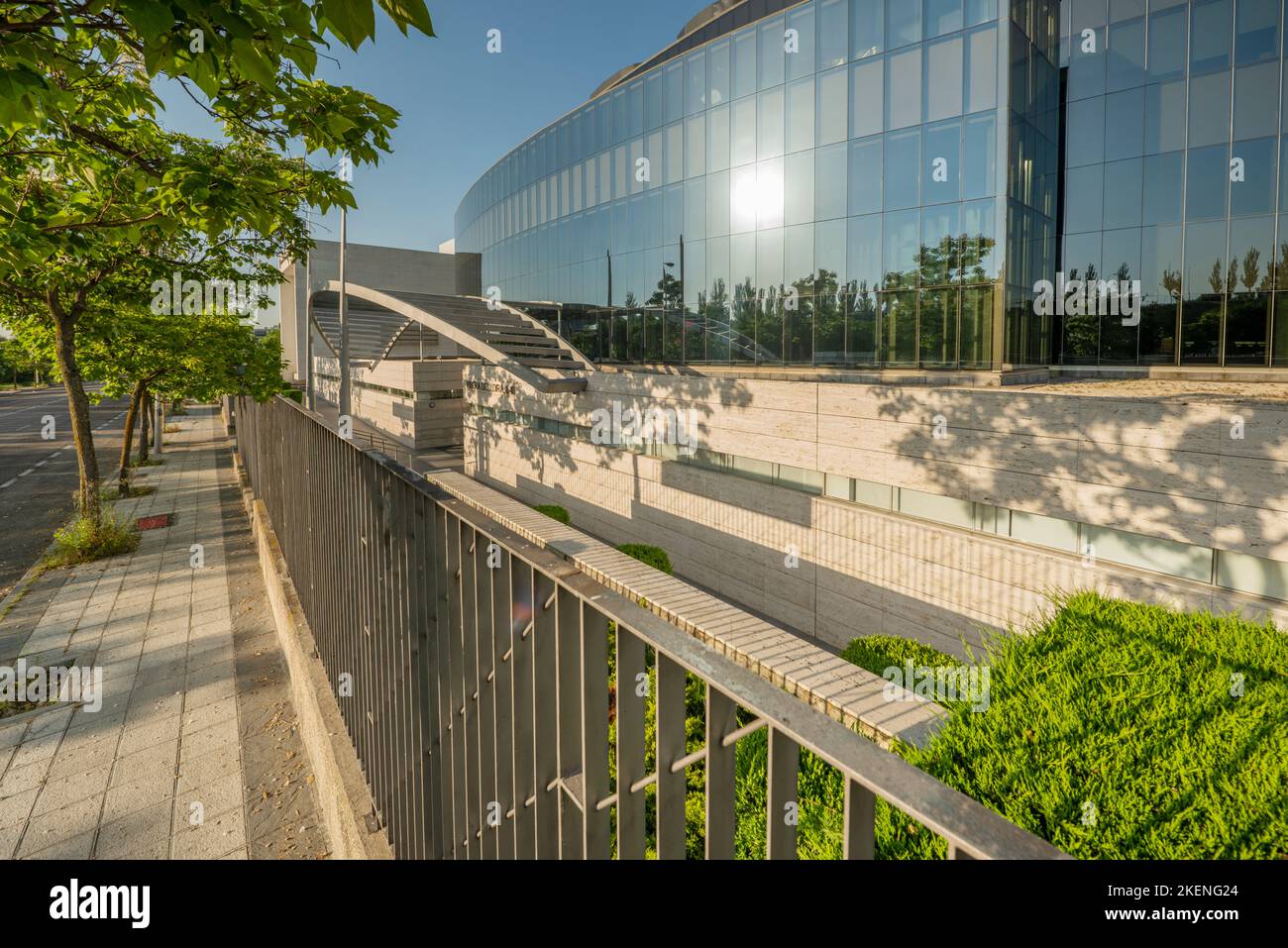 steel railing next to the facade of an office building covered with ...
