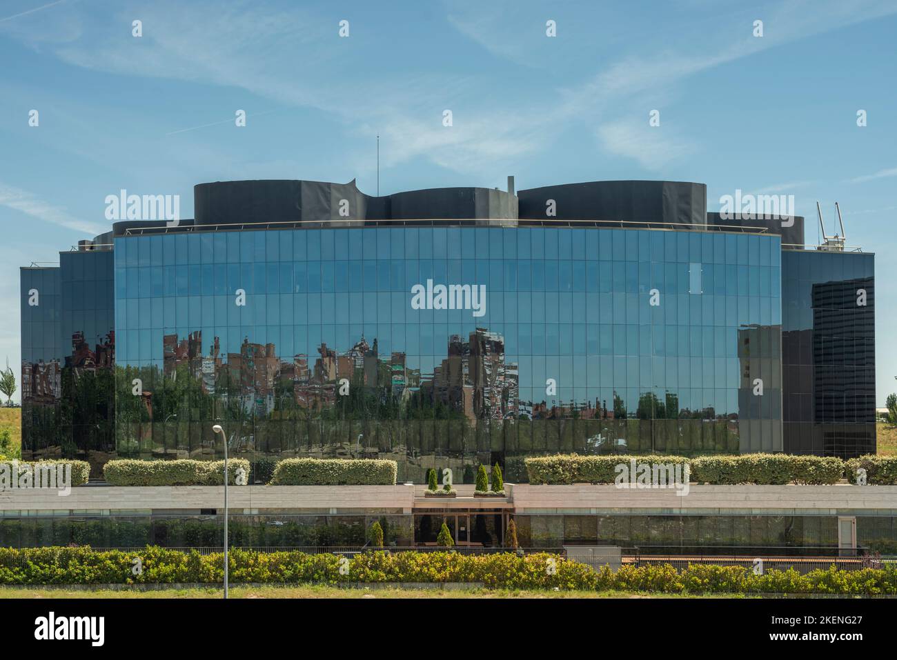 facade of a dark shiny looking steel and glass covered office building ...