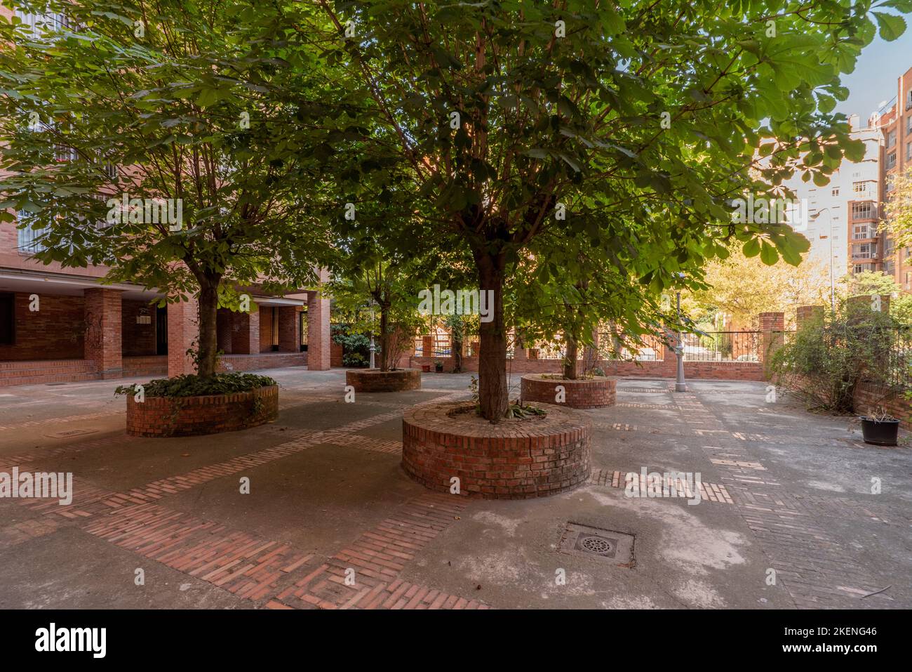 Common areas of an urban residential development with trees in brick ...