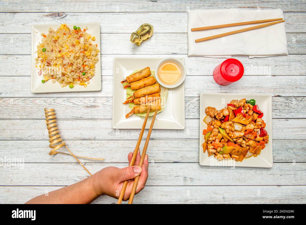 Hand holding wooden chopsticks to eat Vietnamese rolls, three delight ...