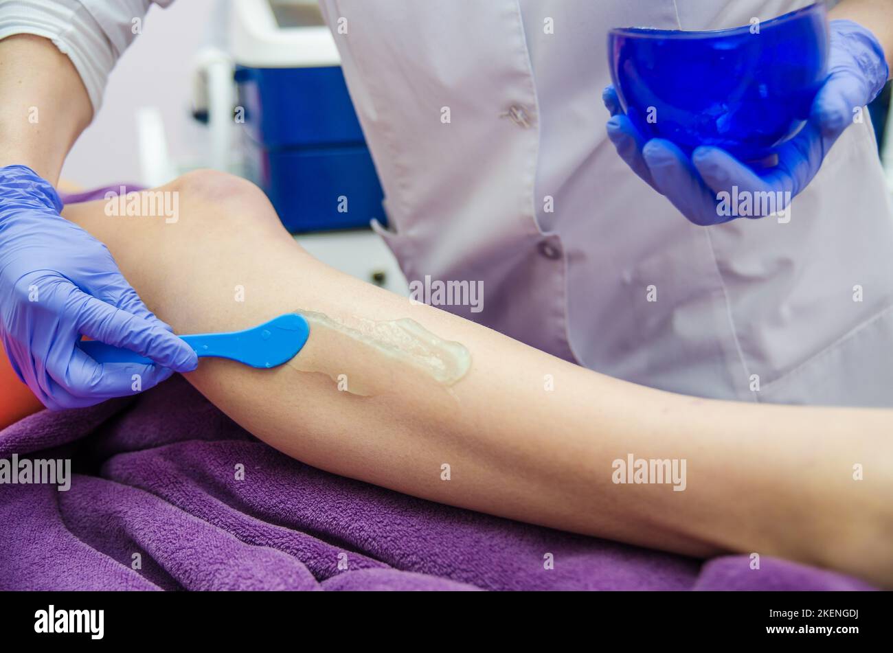 Doctor cosmetologist makes a laser dermal rejuvenation procedure to a ...