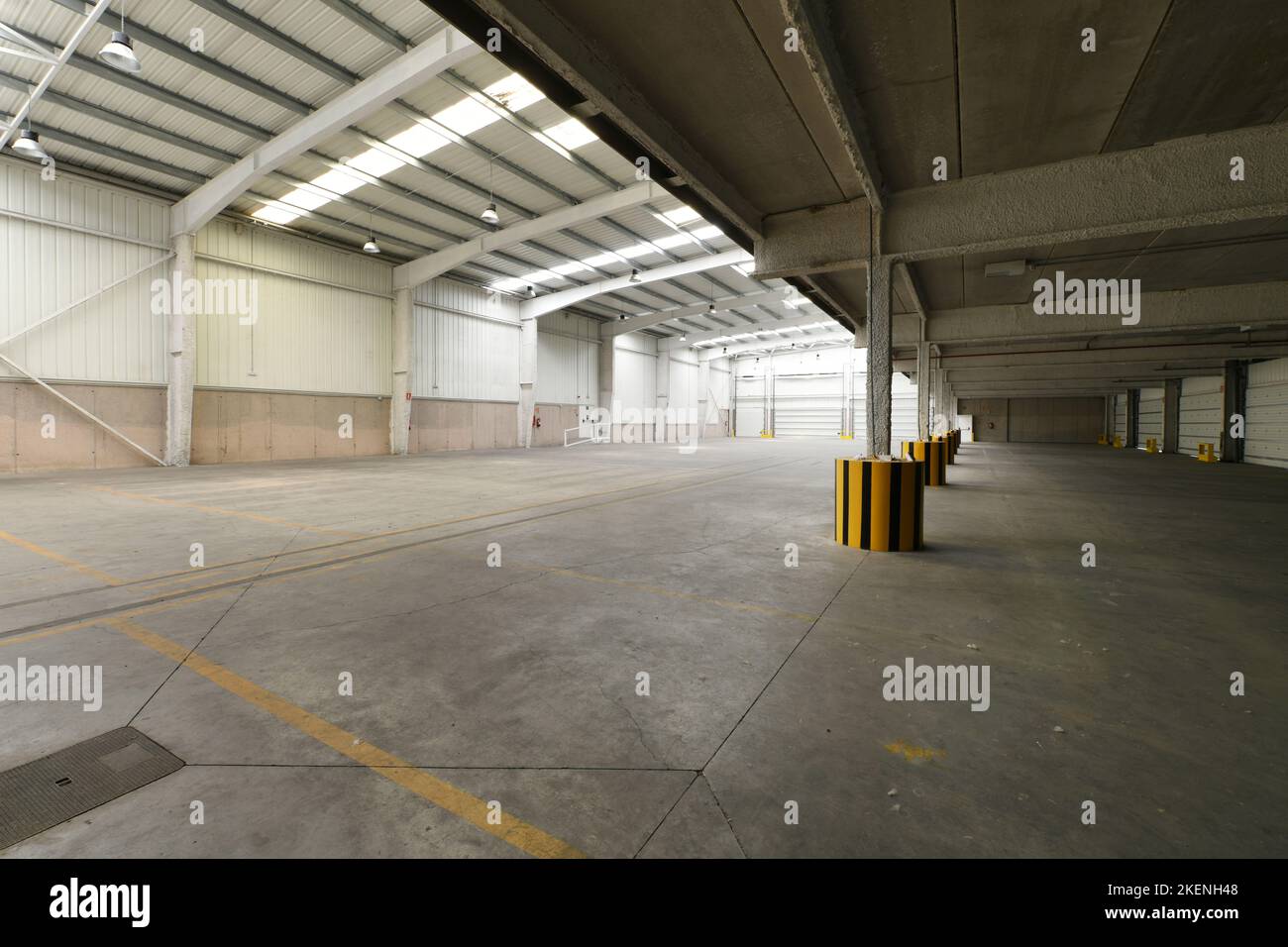 Empty industrial warehouse with corrugated iron roofs with skylights ...