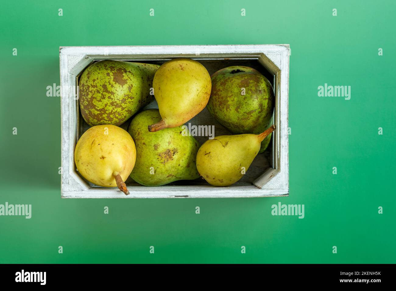 Top view image of white painted wooden crate full of ripe pears of ...