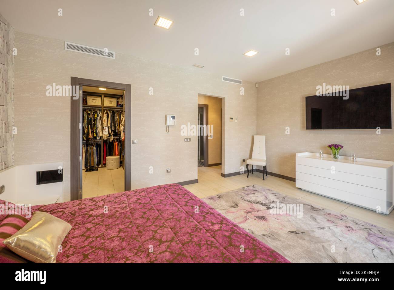 Bedroom with large double bed, chest of drawers with white drawers and ...