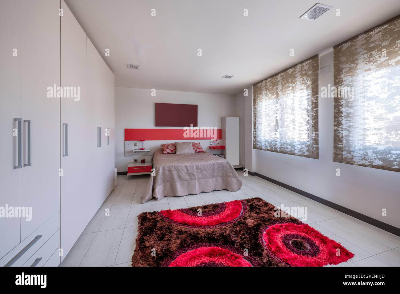 Bedroom with large queen bed with grey, gray side-by-side wardrobe and ...
