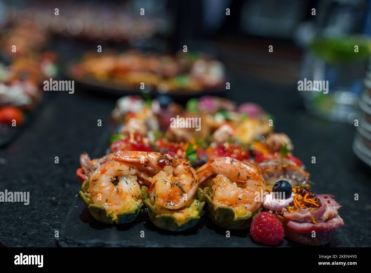 Set of beautiful canapes on black stone plates. Buffet table. Catering ...