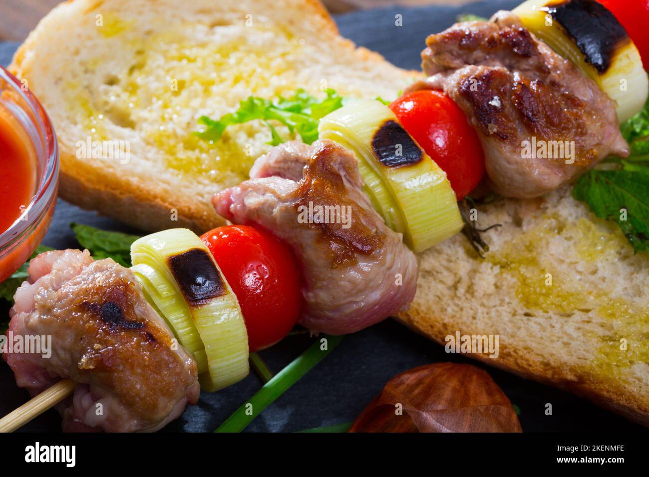 Tasty barbecue of lamb in skewers with cherry tomatoes and onion Stock ...