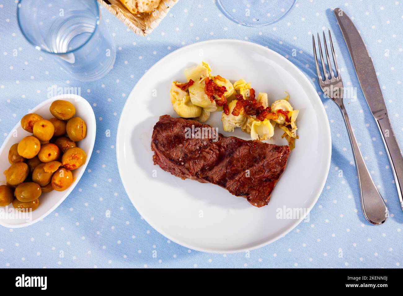 Grilled veal steak with artichokes, healthy dinner Stock Photo - Alamy