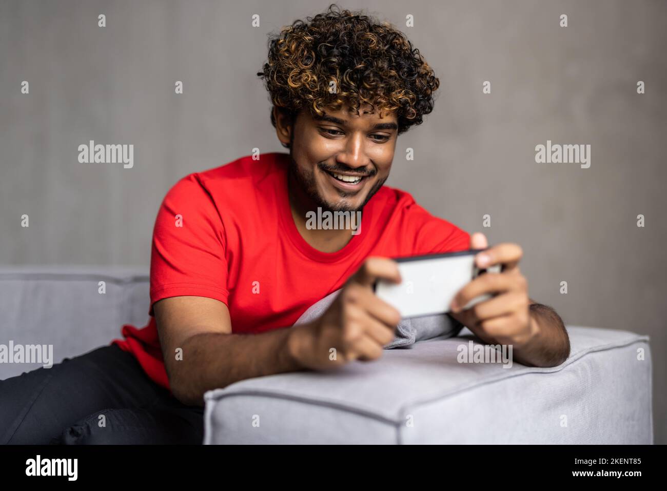 Smartphone social media concept. Indian guy using mobile phone. Asian ...