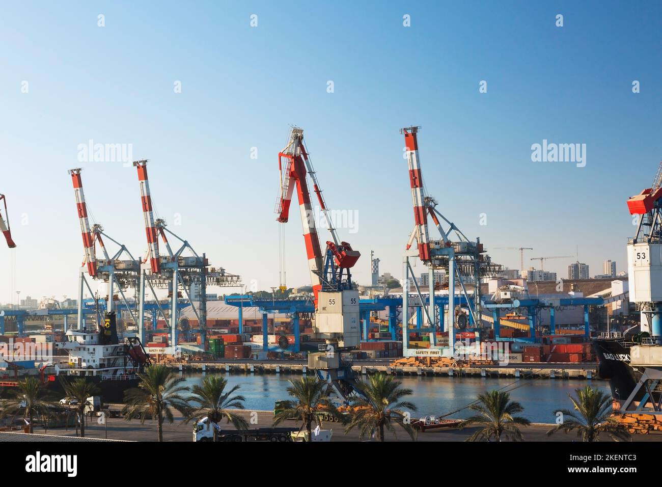 Shipping container loading cranes on dock and docked cargo ships in ...
