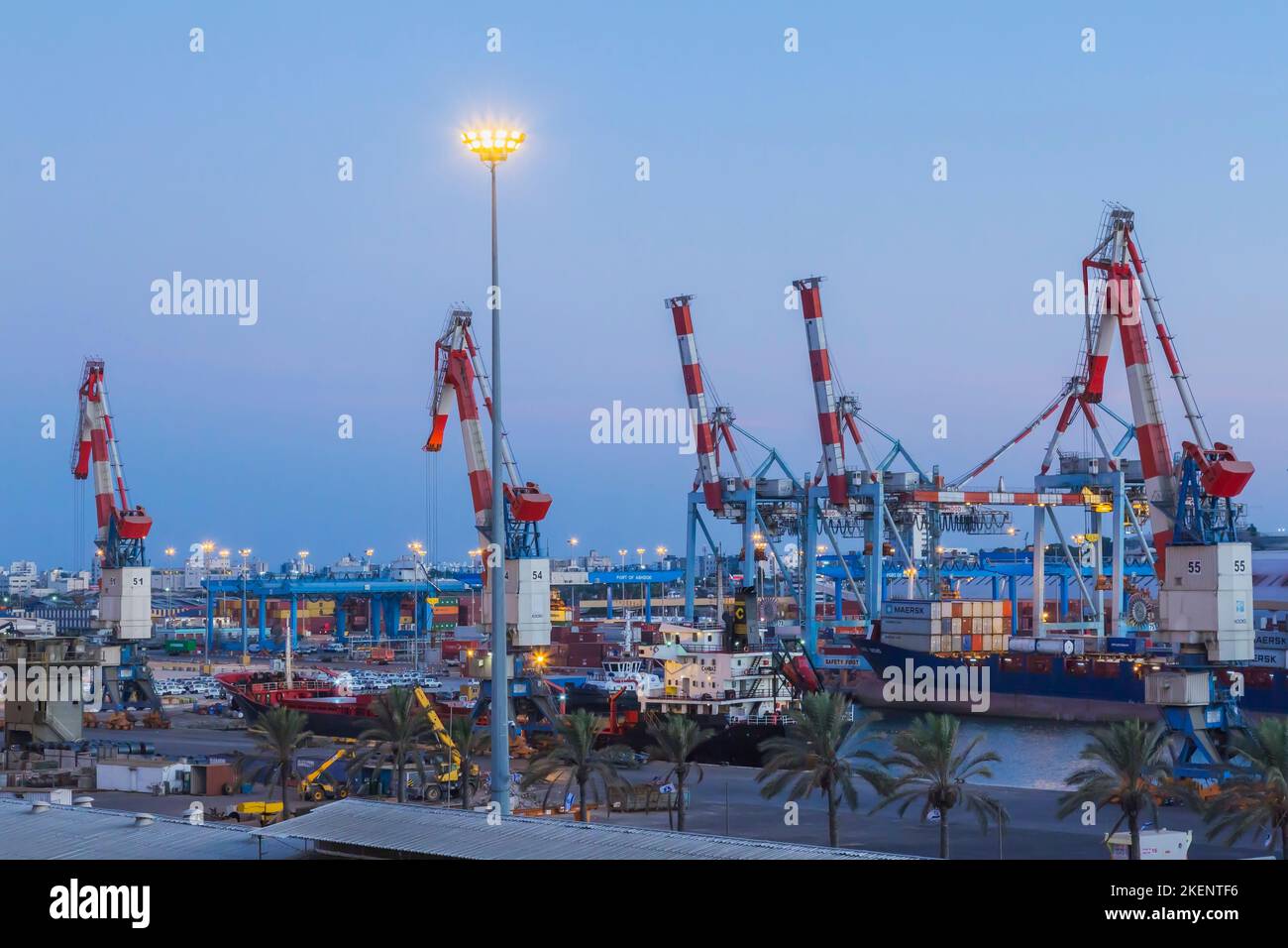 Shipping container loading cranes on dock and docked cargo ships at ...