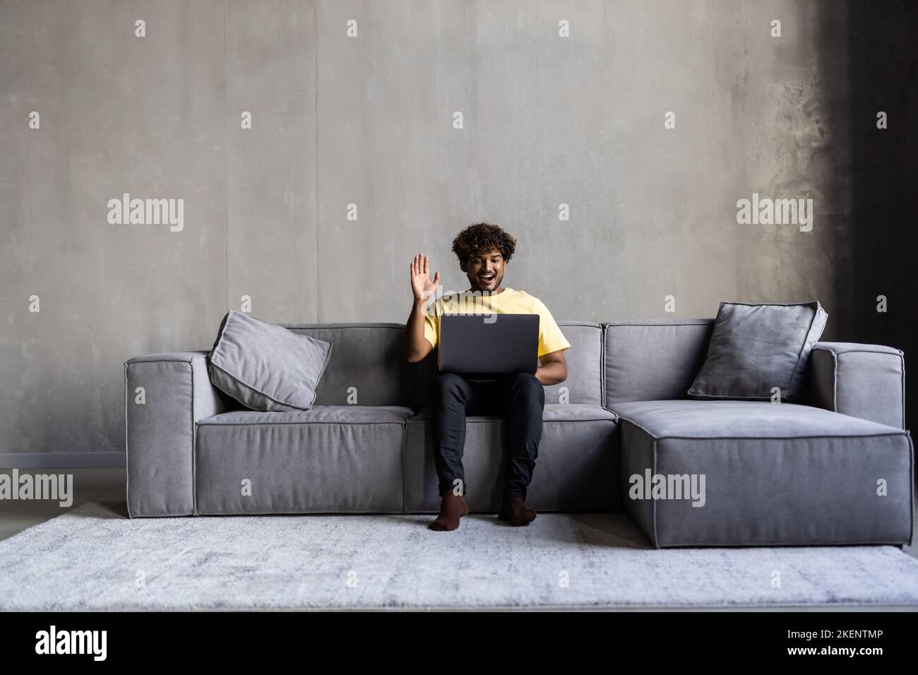 Smiling Indian man having video call waving hand talking to camera ...
