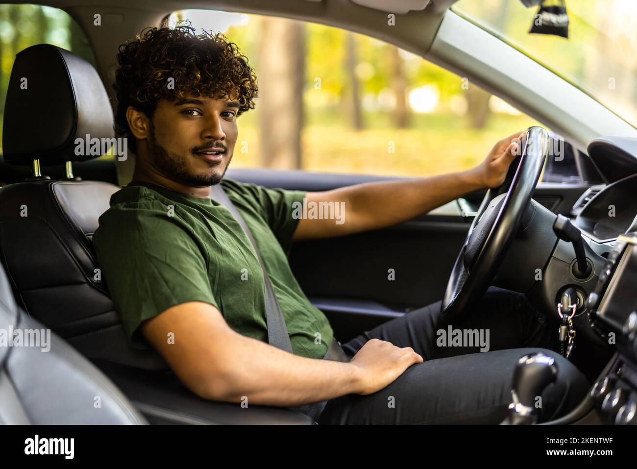 Side view of asian man driving car Stock Photo - Alamy