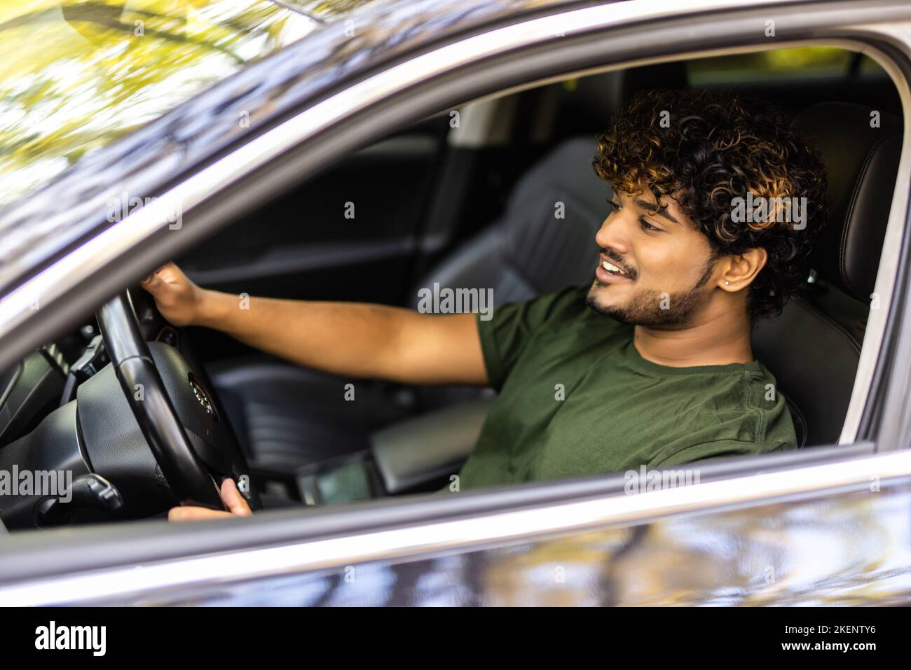 Young handsome Indian man proudly driving his own car Stock Photo - Alamy