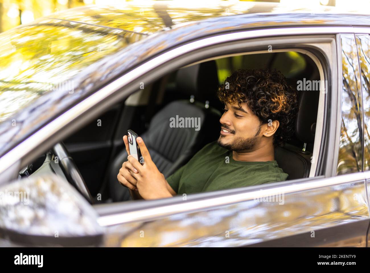 Indian man drive car while hand holding smartphone Stock Photo - Alamy
