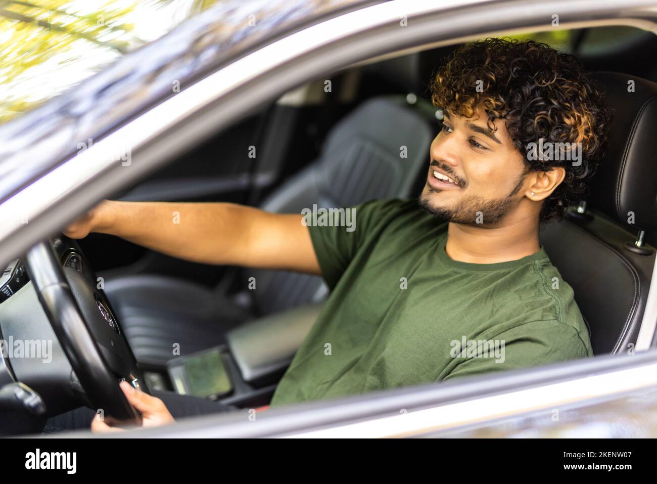 Handsome indian man driving car hi-res stock photography and images - Alamy