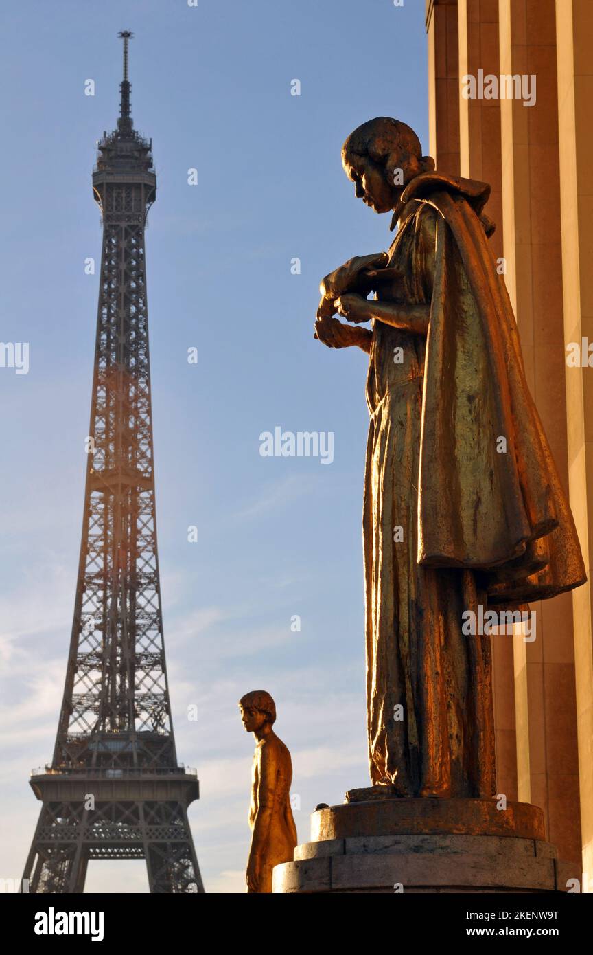 The Eiffel Tower rises behind gilded statues on the terrace of the ...