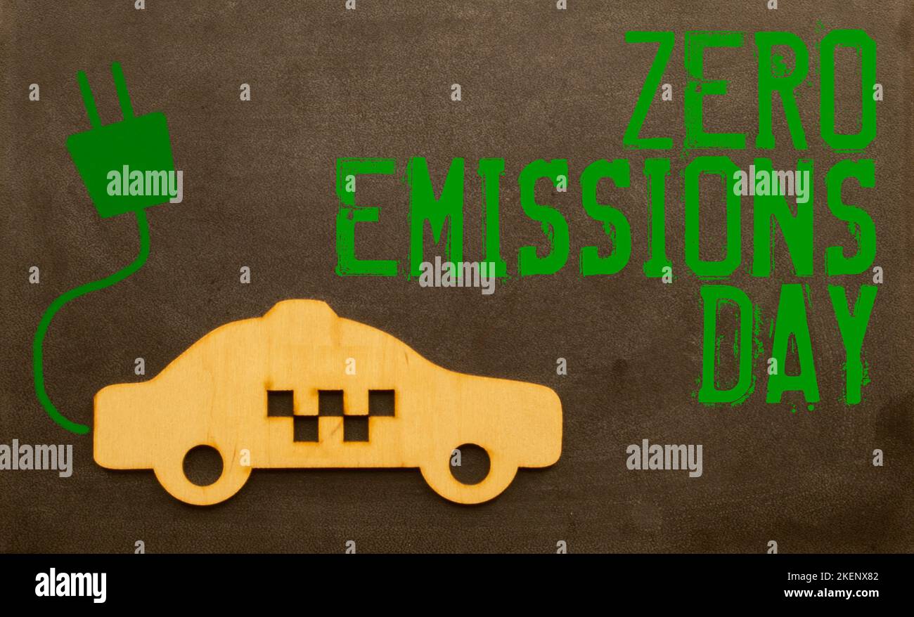 Ecological concept. On a white-green surface, a car and a cardboard ...