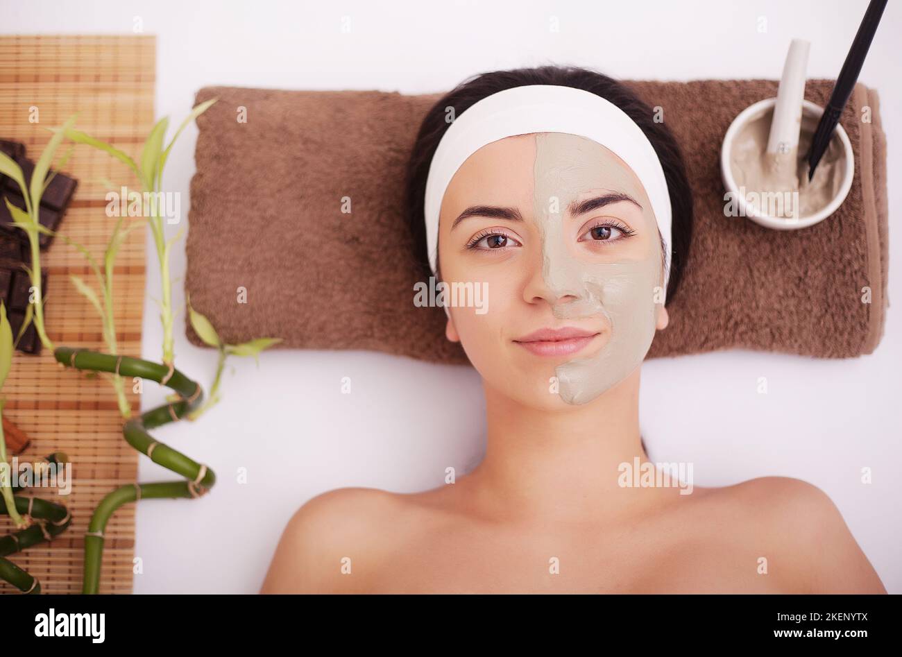 Young woman having clay skin mask treatment on her face Stock Photo - Alamy