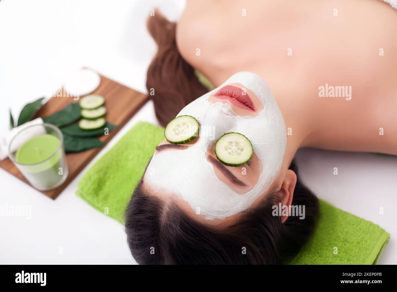 Therapist applying a face mask to the face of a beautiful young blonde ...