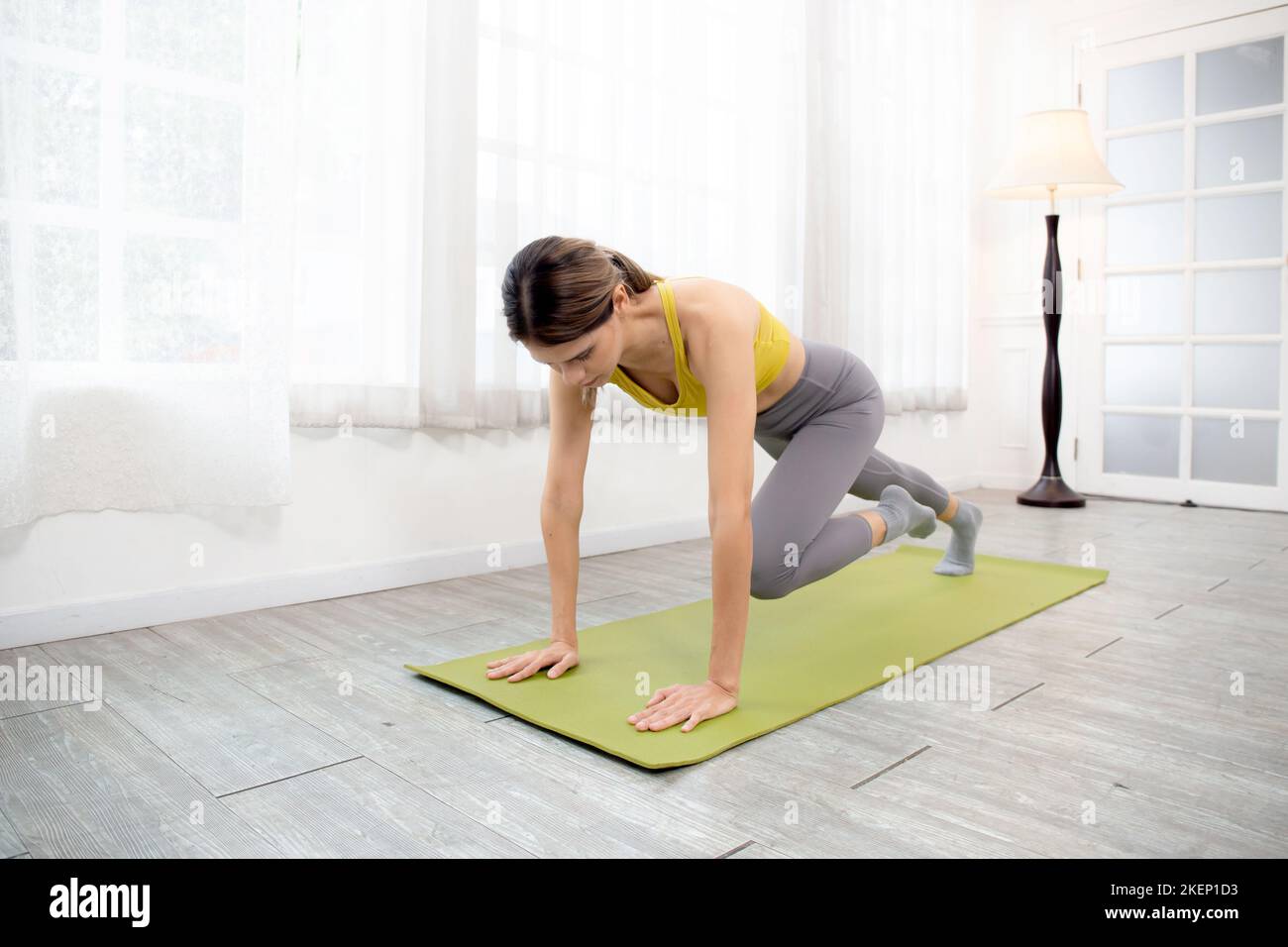 Beautiful young caucasian woman practicing workout exercise with plank ...
