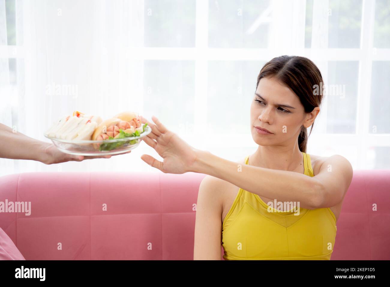 Hands serving food and young caucasian woman making sign say no food ...