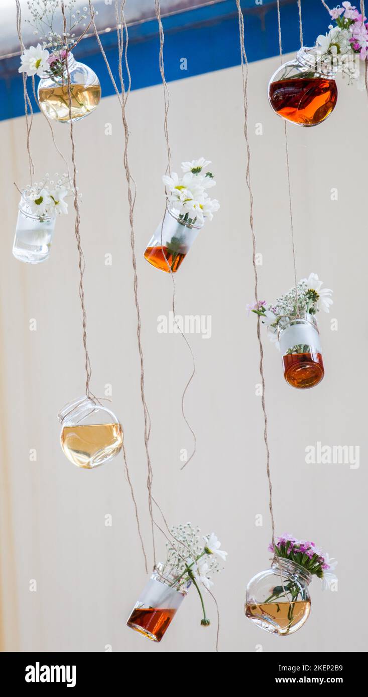 Herbal tea bottles with flowers hanging on strings Stock Photo - Alamy