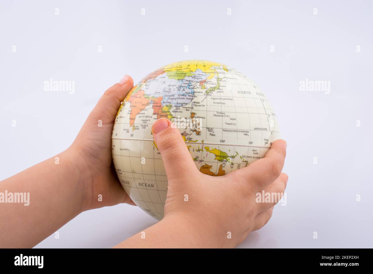 Child holding a globe in his hand on a white background Stock Photo - Alamy