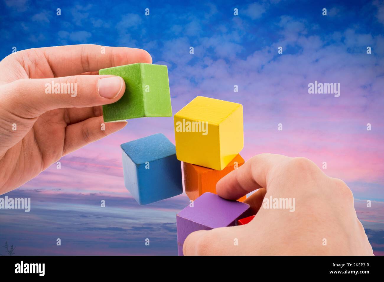 Hand playing with colorful cubes on a background Stock Photo - Alamy