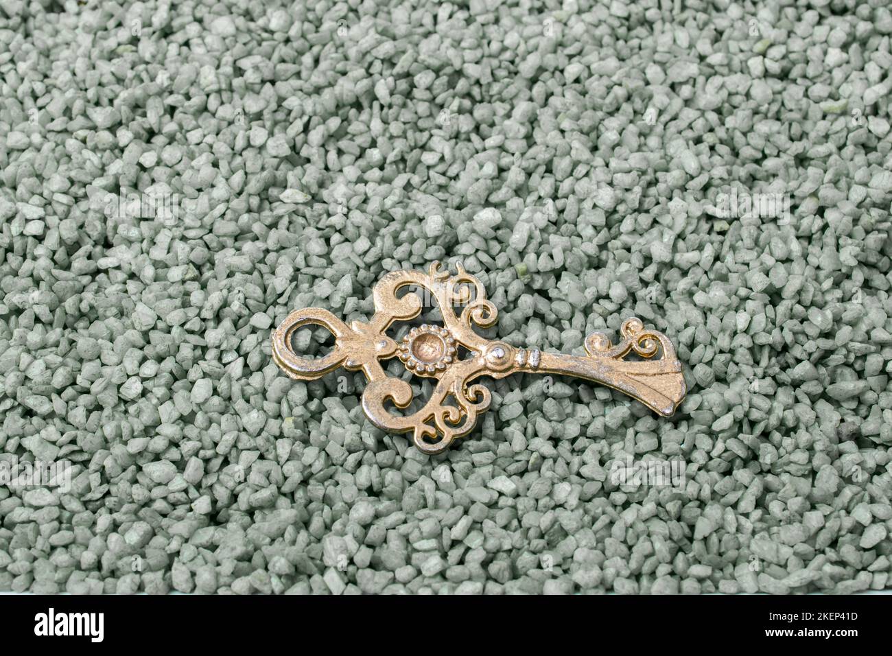 Retro style gold color key on green sand Stock Photo - Alamy