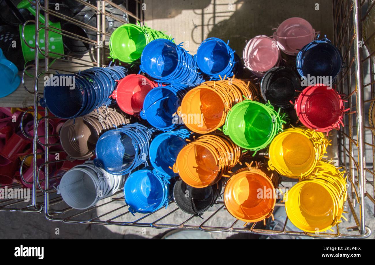 Little set of buckets of various colors in a market place Stock Photo ...