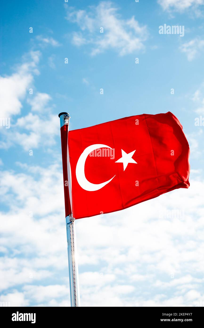 Red Turkish flag on pole on a cloudy sky Stock Photo - Alamy