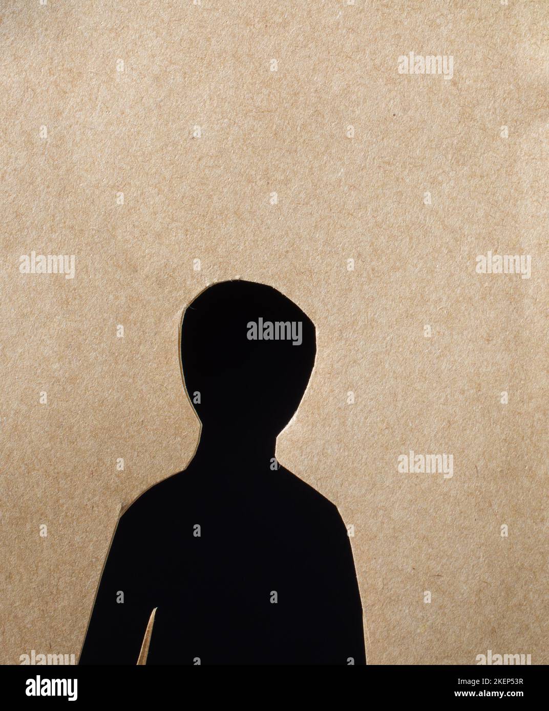 Man shape cut out of paper in hand in the view Stock Photo - Alamy