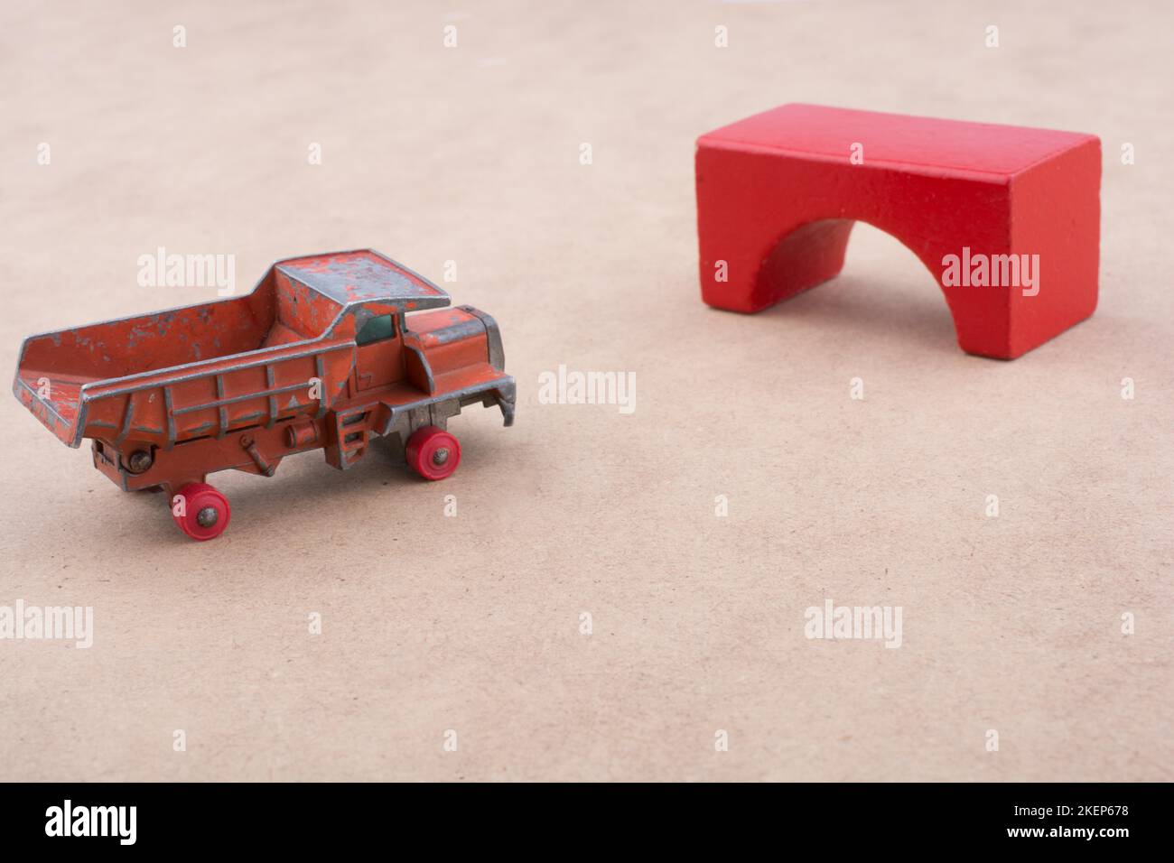 Toy car truck near a brick on a wooden background Stock Photo - Alamy