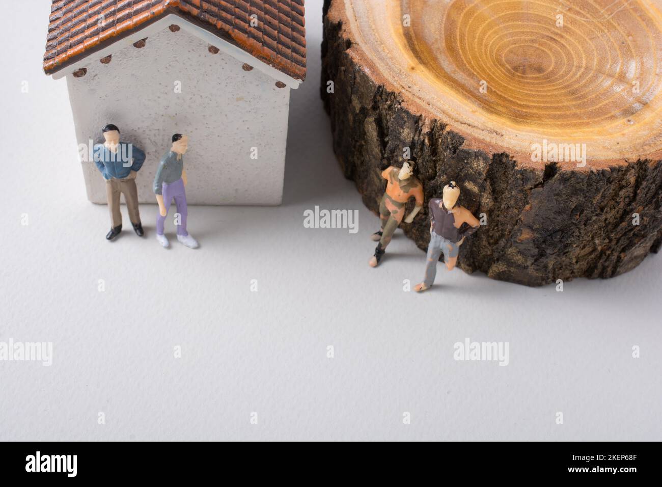 Tiny figurine of man miniature before a house and a tree Stock Photo ...