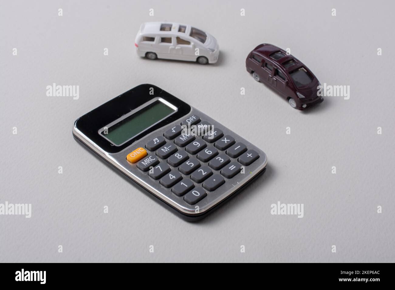 Little size cars beside a calculator on white background Stock Photo ...