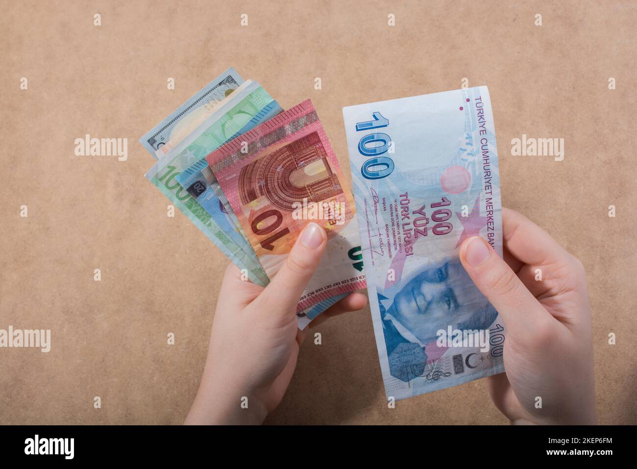 Hand holding American dollar banknotes isolated on wooden background ...