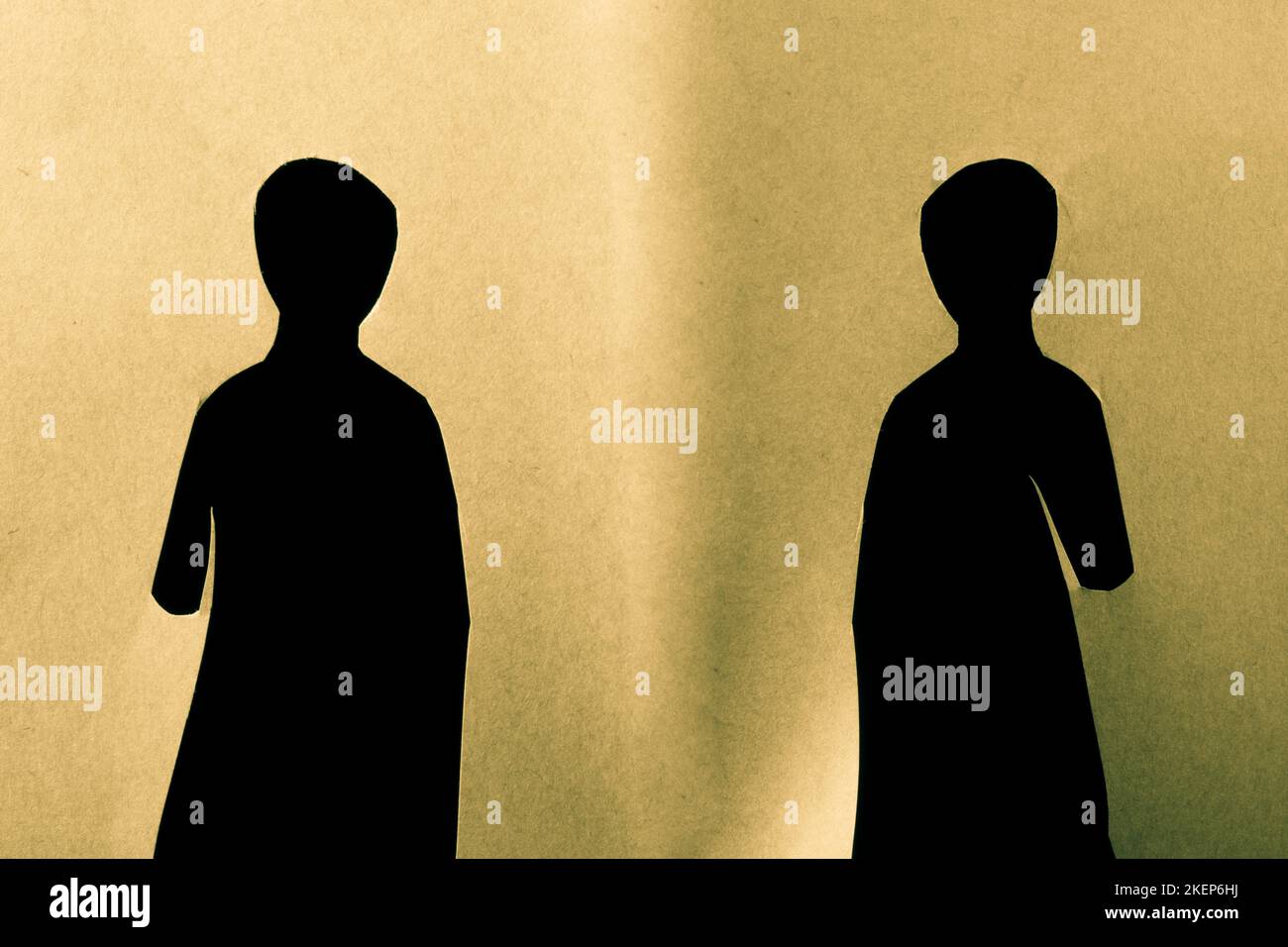 Man shape cut out of paper in hand in the view Stock Photo - Alamy