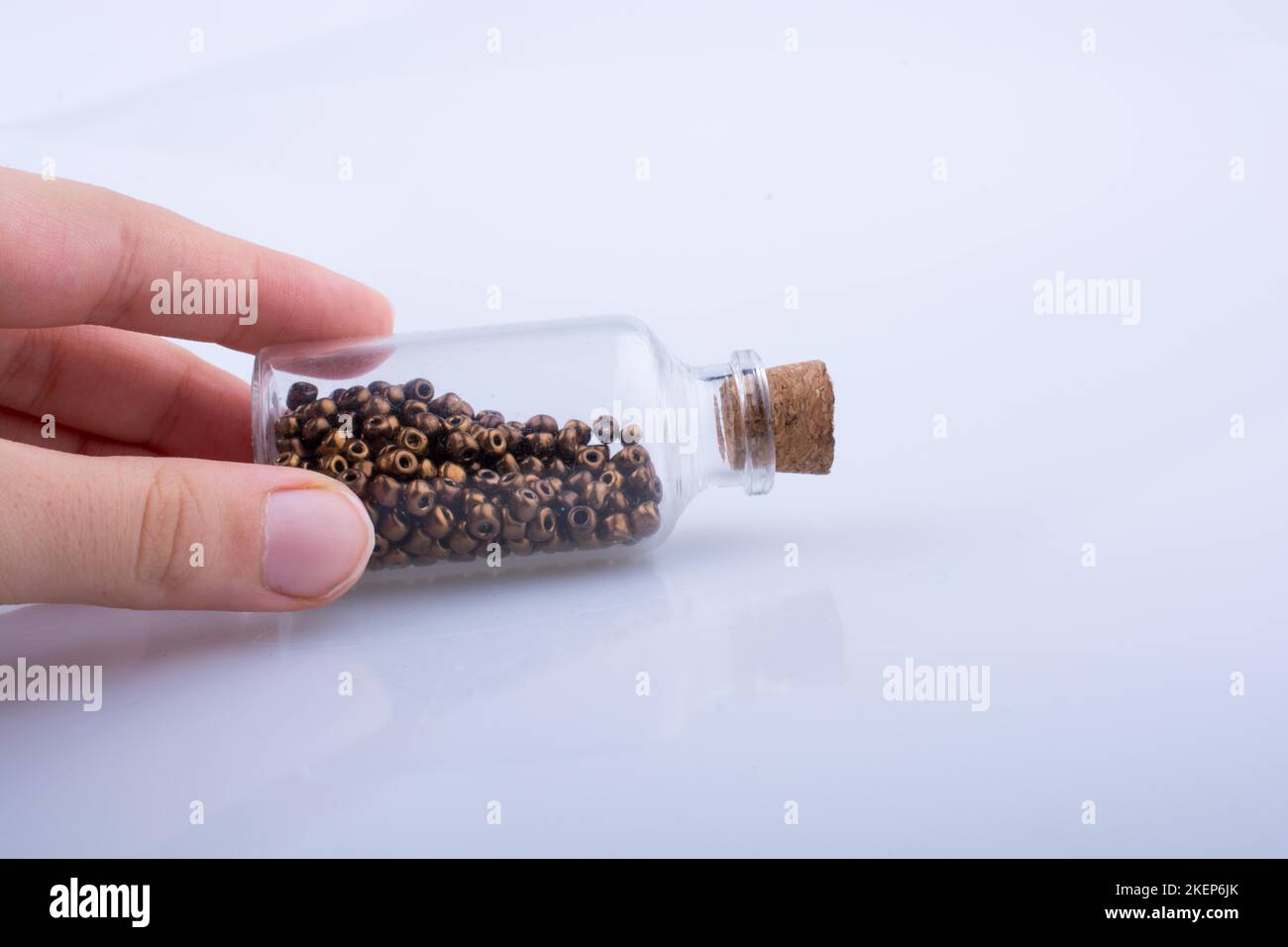 Little perfume glass bottle in hand on a white background Stock Photo ...