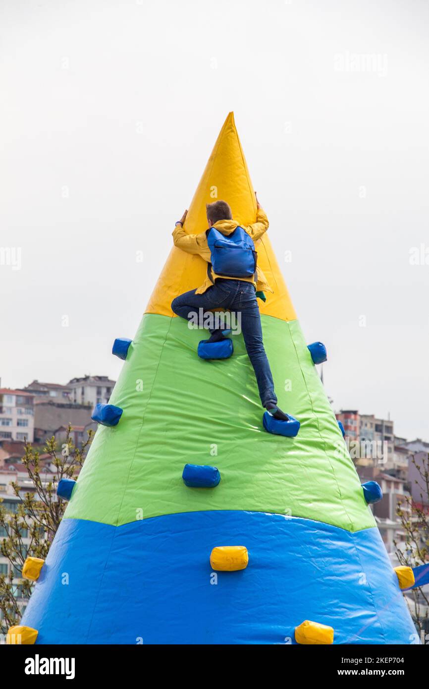 A boy climbing on cone shaped climbing course Stock Photo - Alamy